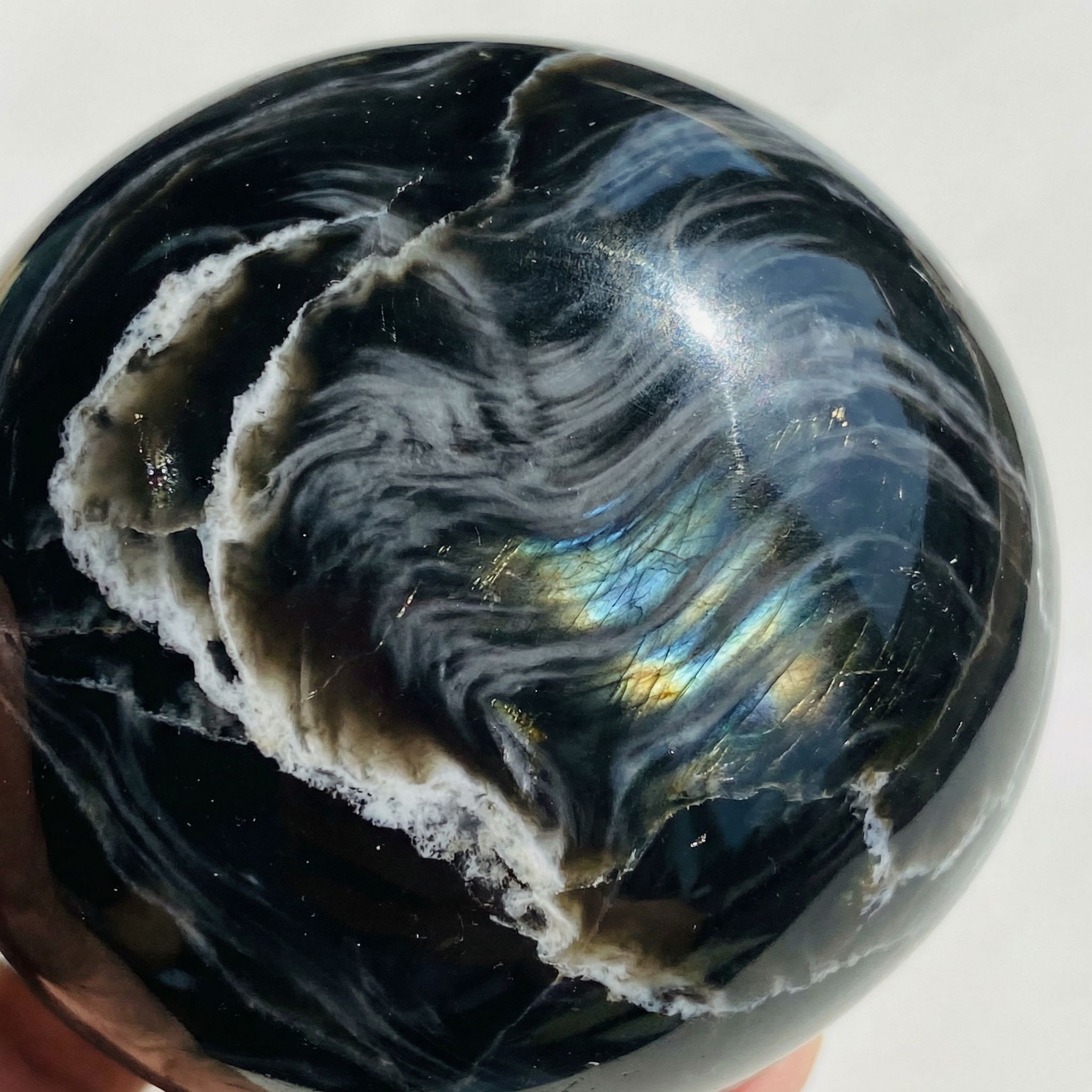 Nano Banana prompt: Black obsidian with white veins flowi...